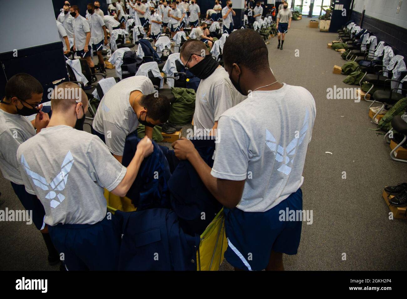 Military basic trainees place blues uniform service coats in a bin for ...