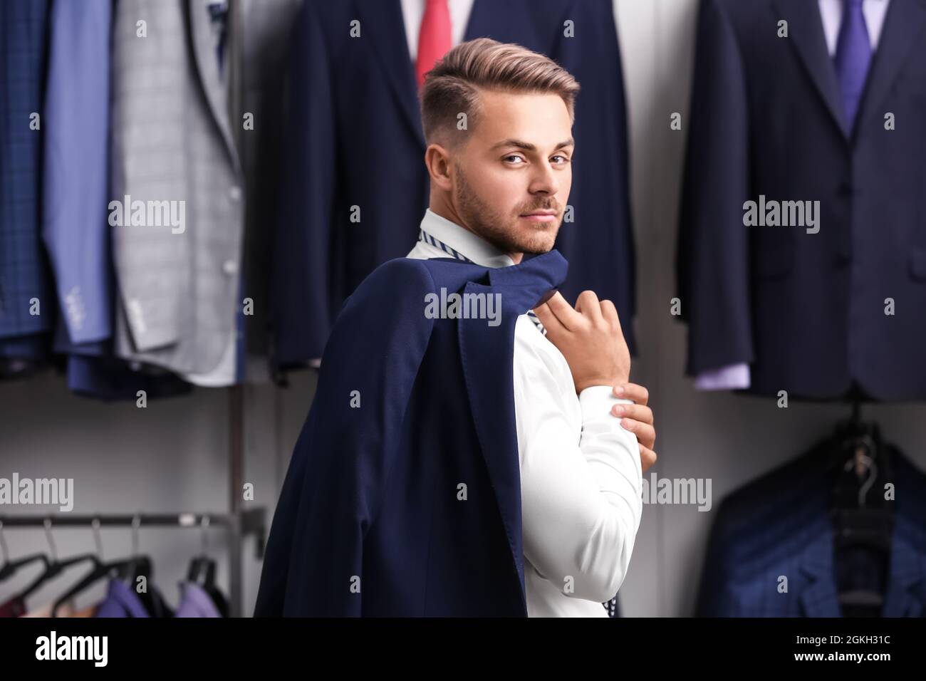 Handsome man in luxury suit store Stock Photo - Alamy