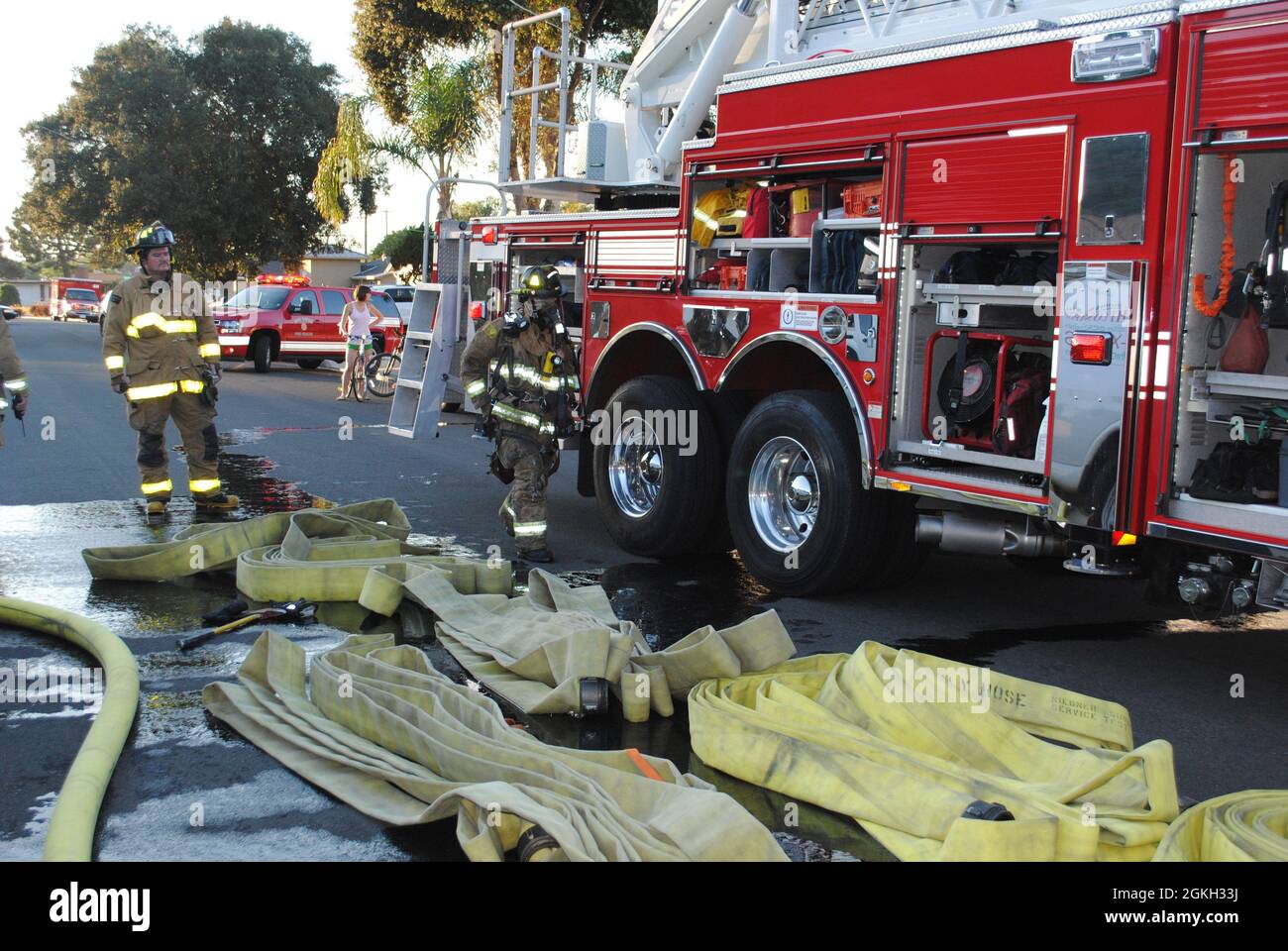 San Diego Fire-Rescue Firefighters pick up hose after a structure fire ...