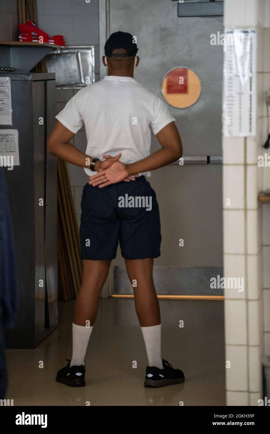 The recruit chief petty officer for division 222 stands at parade rest ...