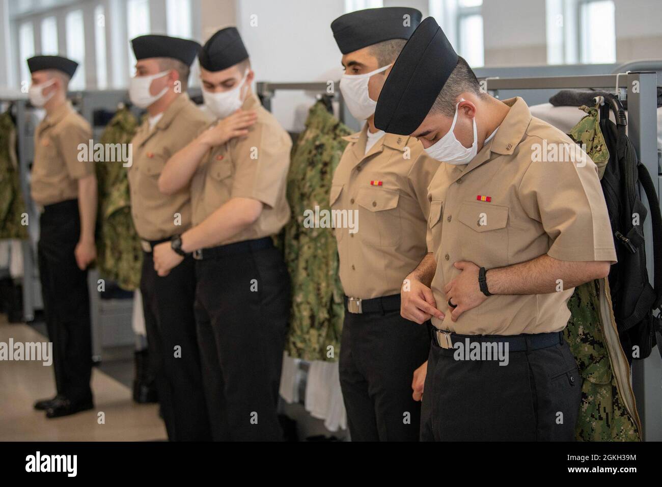 Recruits make final corrections to their wear of the navy service ...