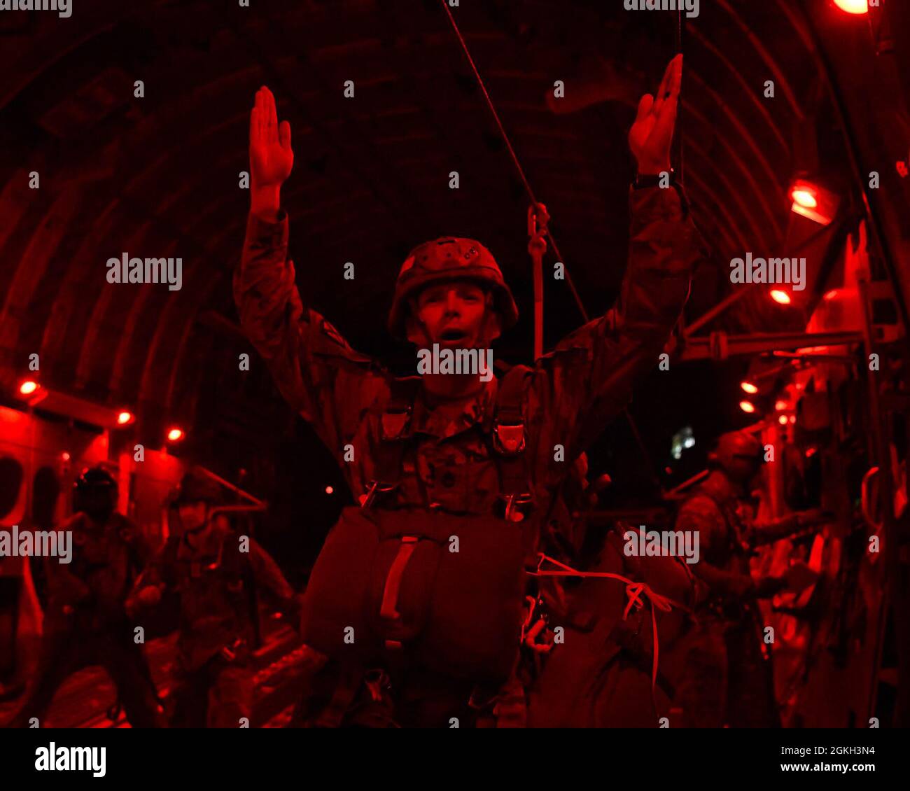 A jumpmaster assigned to the 82nd Airborne Division signals his ...