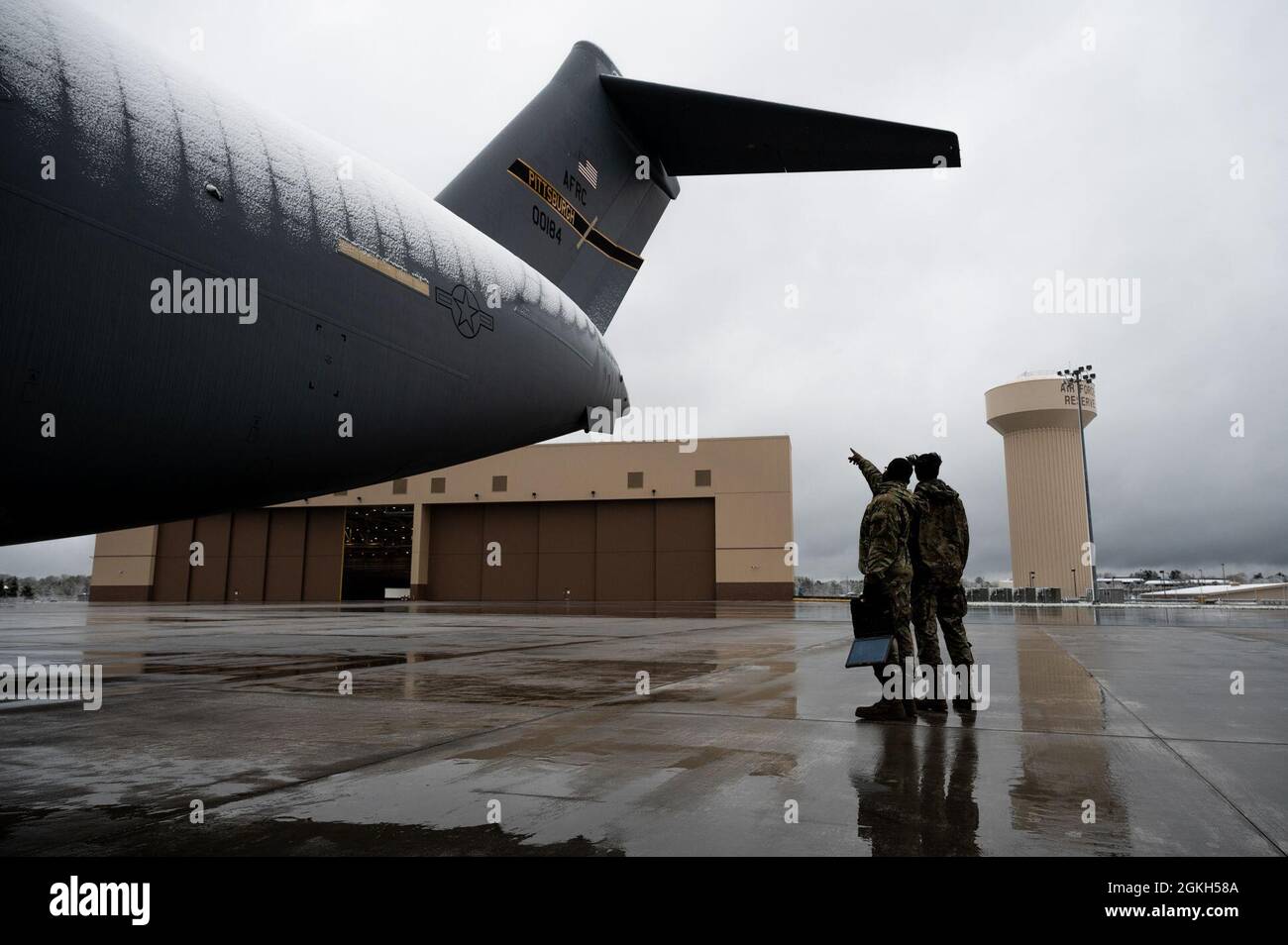 Airmen assigned to the 911th Aircraft Maintenance Squadron inspect a C ...