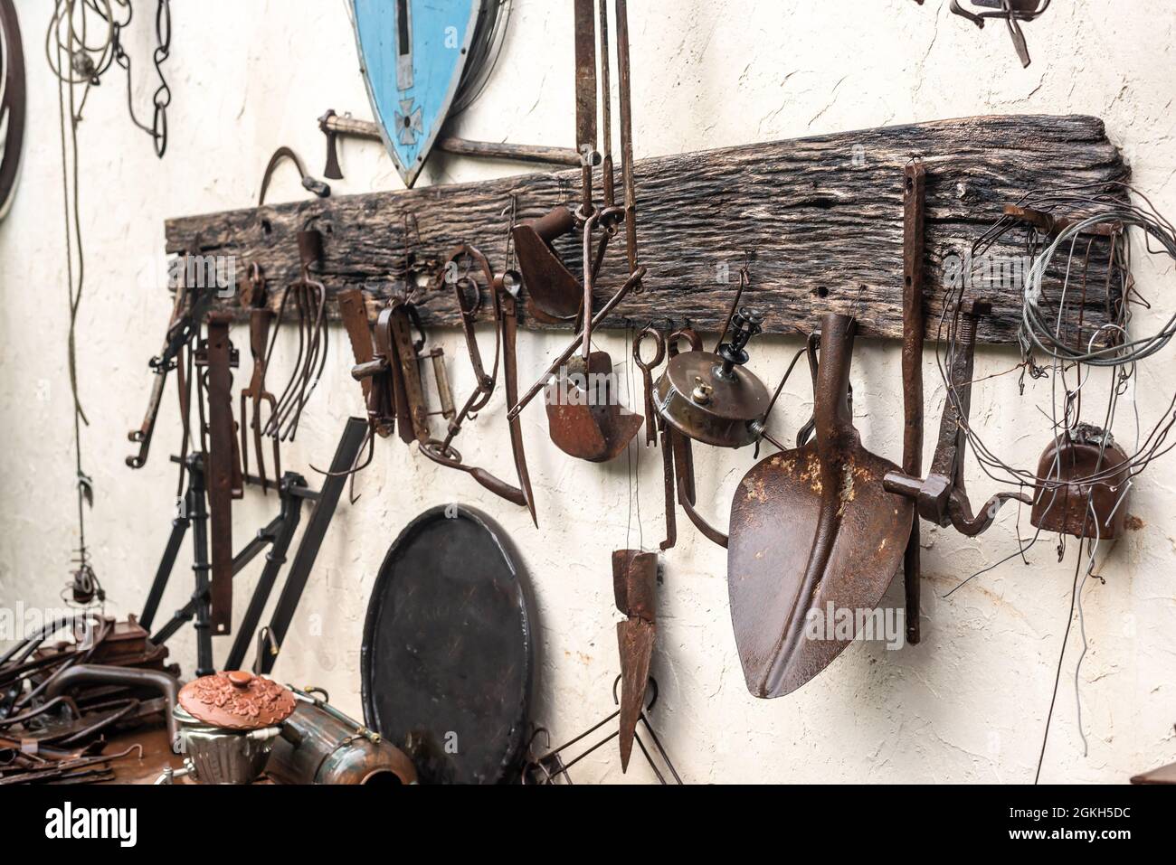 Gardening tools and instruments hang on country house wall Stock Photo ...