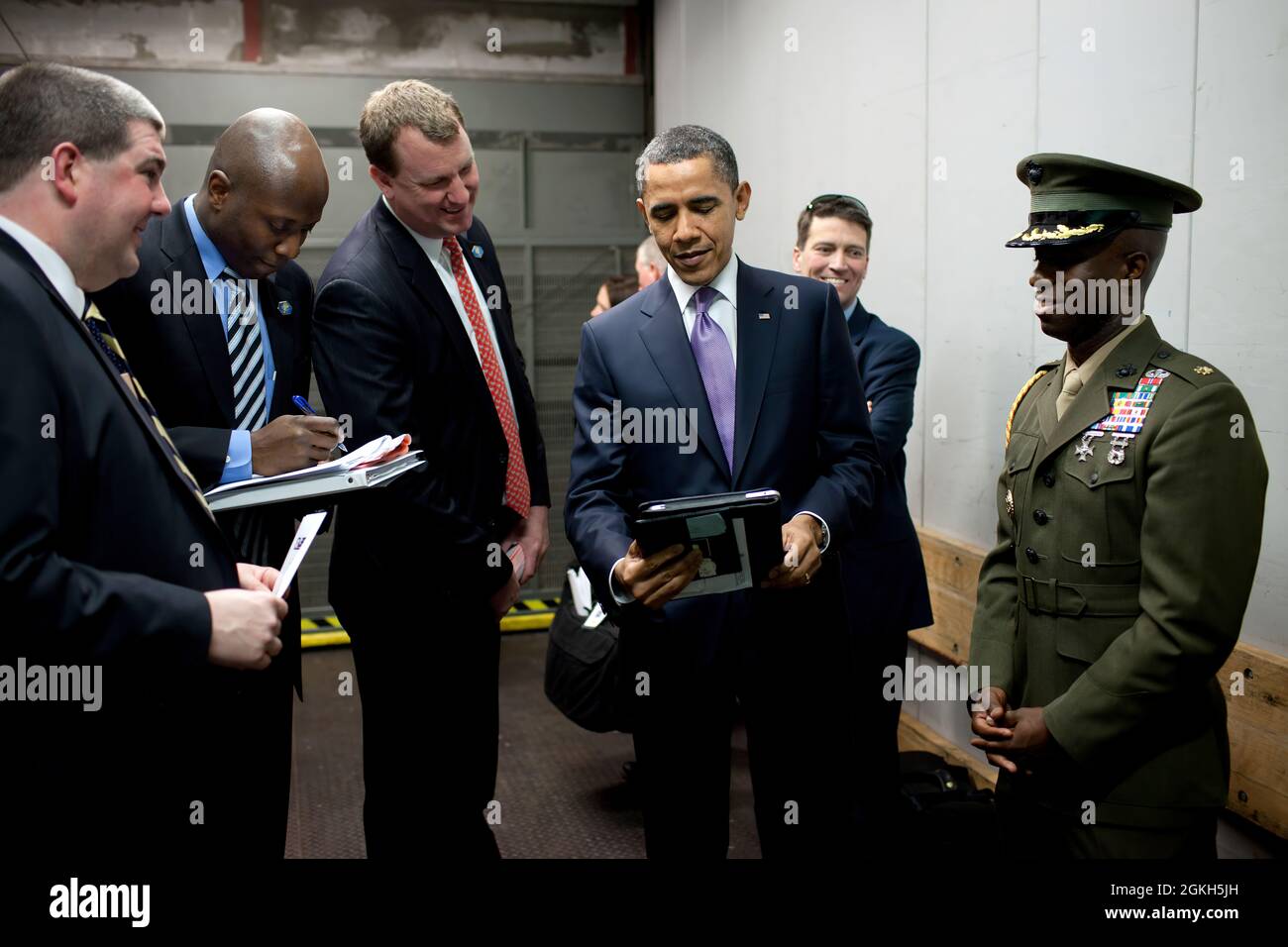 President Barack Obama looks on a IPad at pictures of White House ...