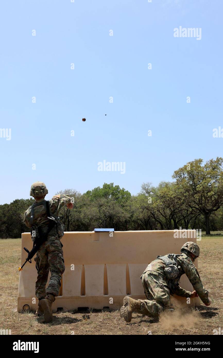 Spc. Karhl Wayman and Spc. Christopher Thompson throw inert grenades during the grenade toss ...
