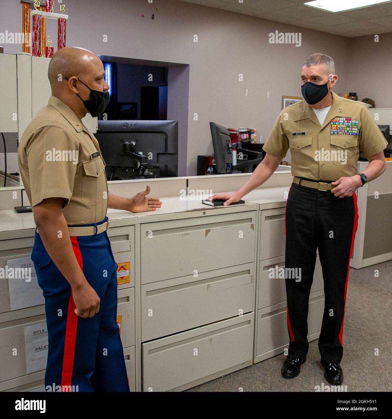 U.S. Marine Corps Chief Warrant Officer 3 Raymond Garciacortijo, left ...