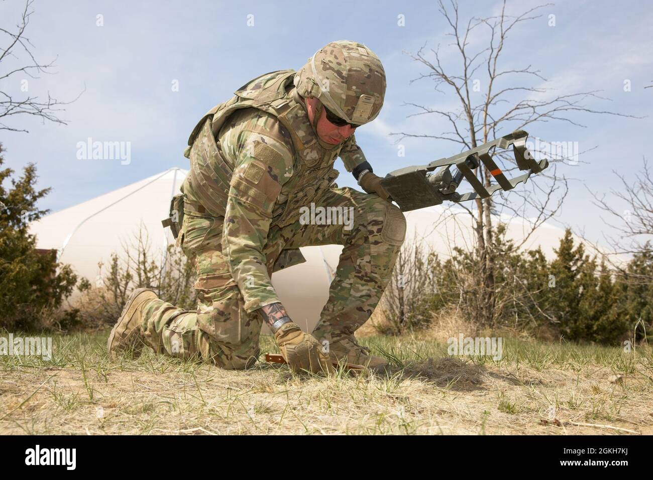 Staff Sergeant Brandon Grissom, 3rd EOD Bn, 707 EOD Co. probes around a ...