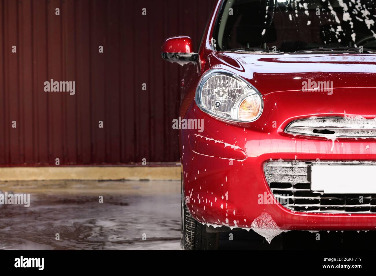 Red automobile at car wash Stock Photo - Alamy