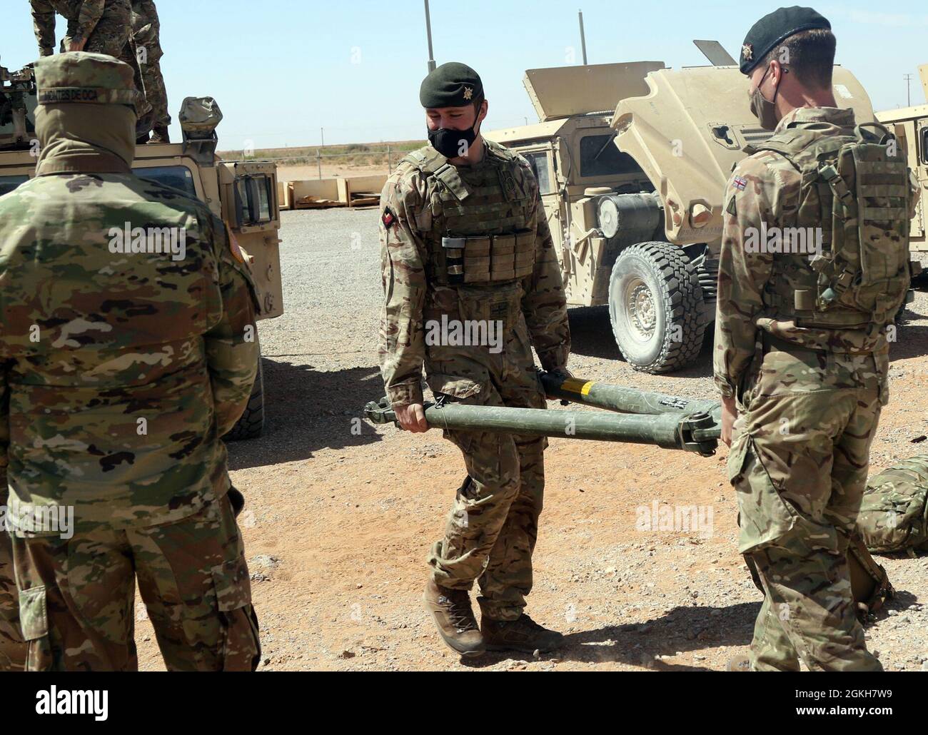 Soldiers with the British Army carry a tow bar to demonstrate the steps ...