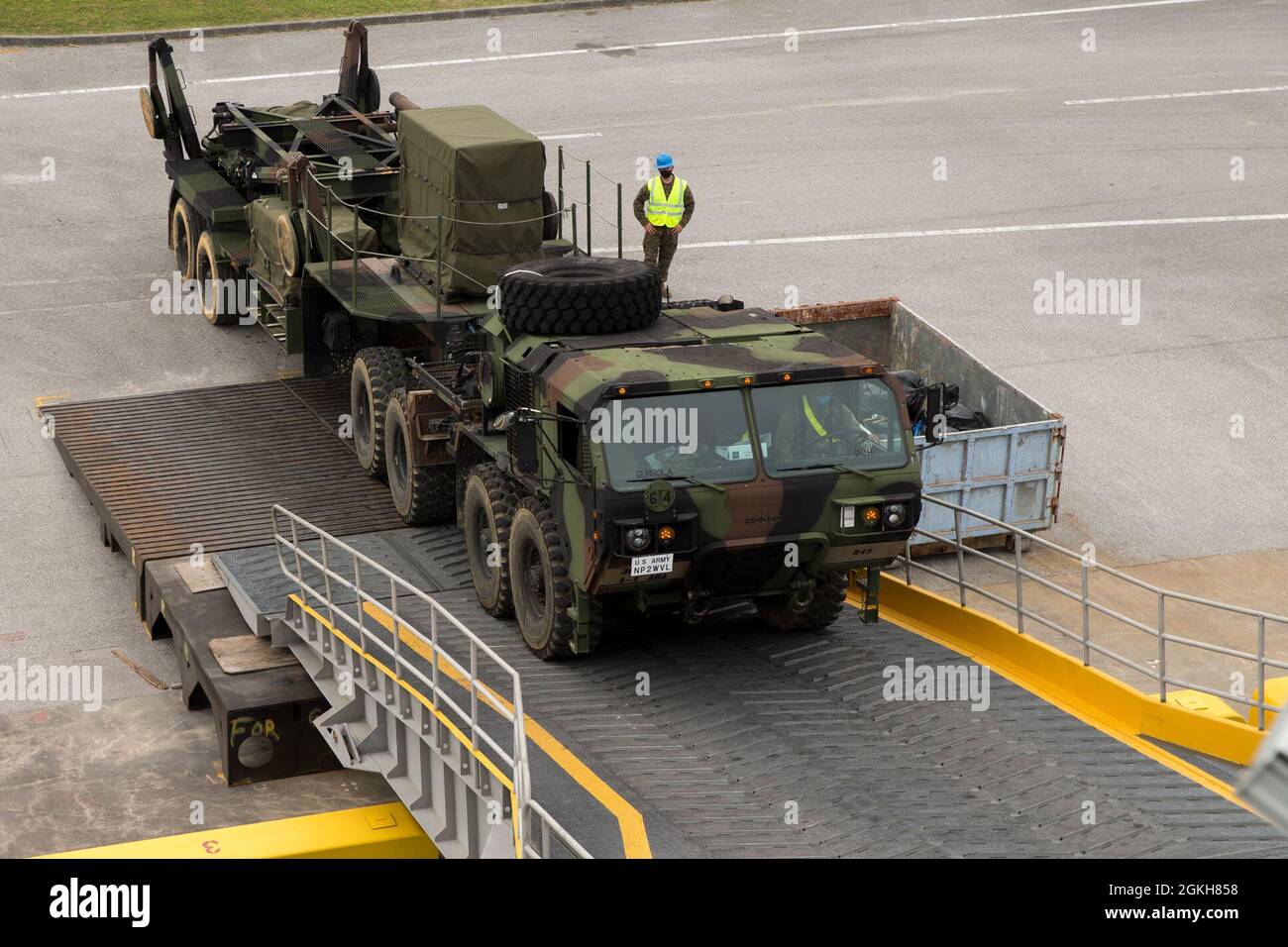 A U.S. Marine with III Marine Expeditionary Force guides a U.S. Army ...