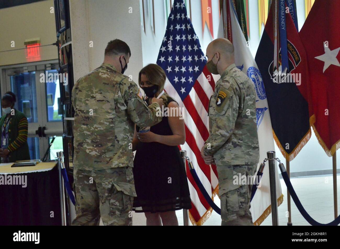Soldier and Family Readiness Groups Volunteer of the Year Kassie Peterson accepts her award from ...