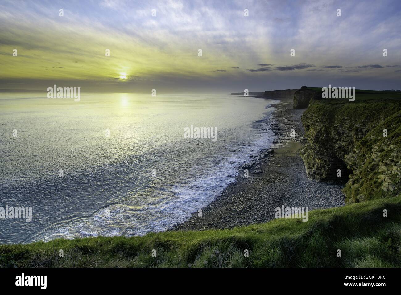 Landscape of cliffs covered in greenery surrounded by the sea during a ...