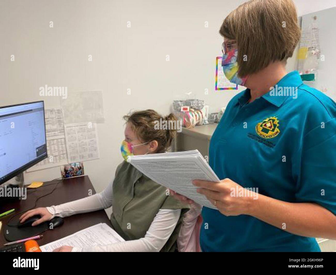 Nurses Ashley Woodruff (left) and Erin Richter, discuss documentation ...