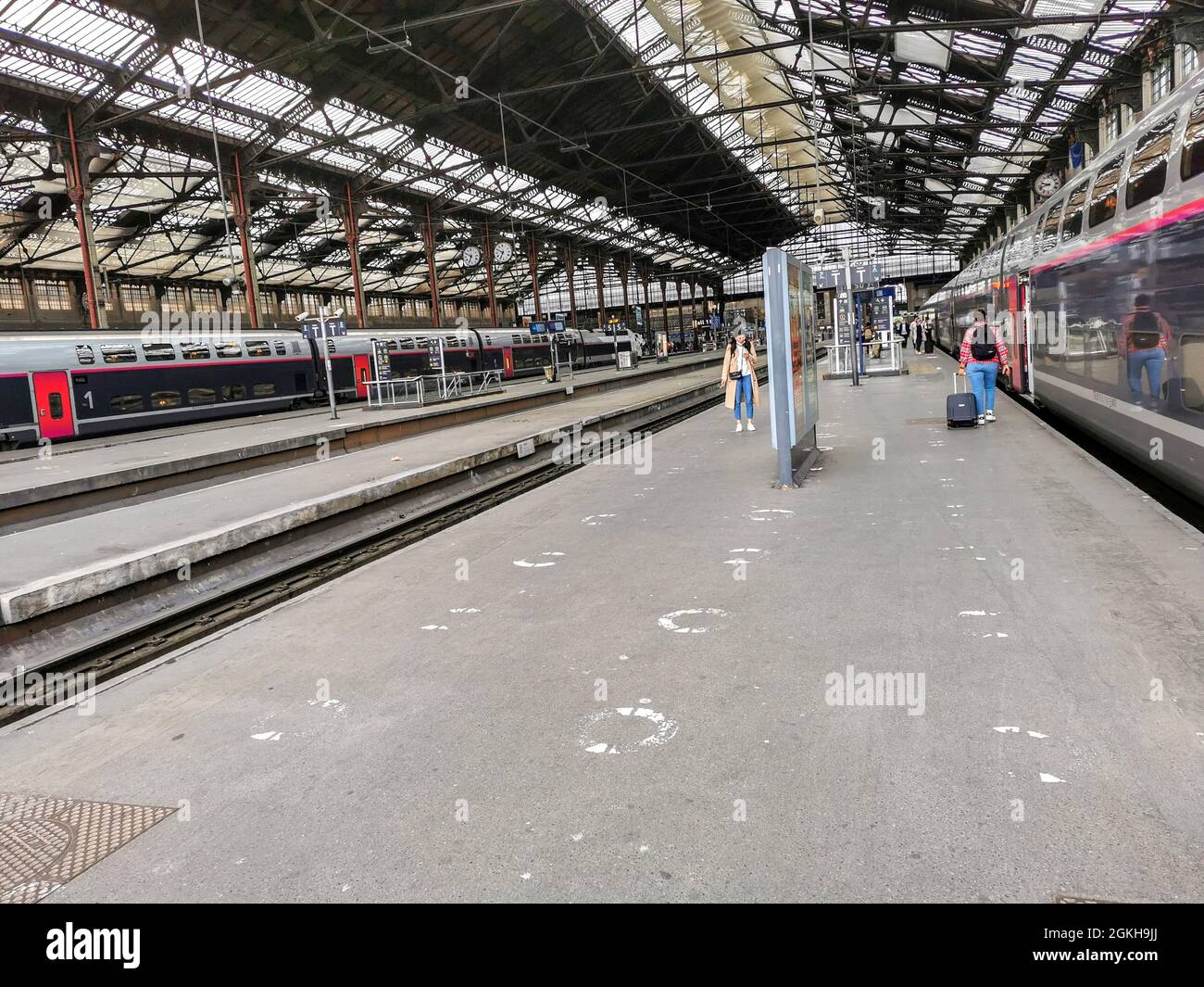 France, Paris, 2021-07-01. A woman pulls a suitcase on the platform of ...