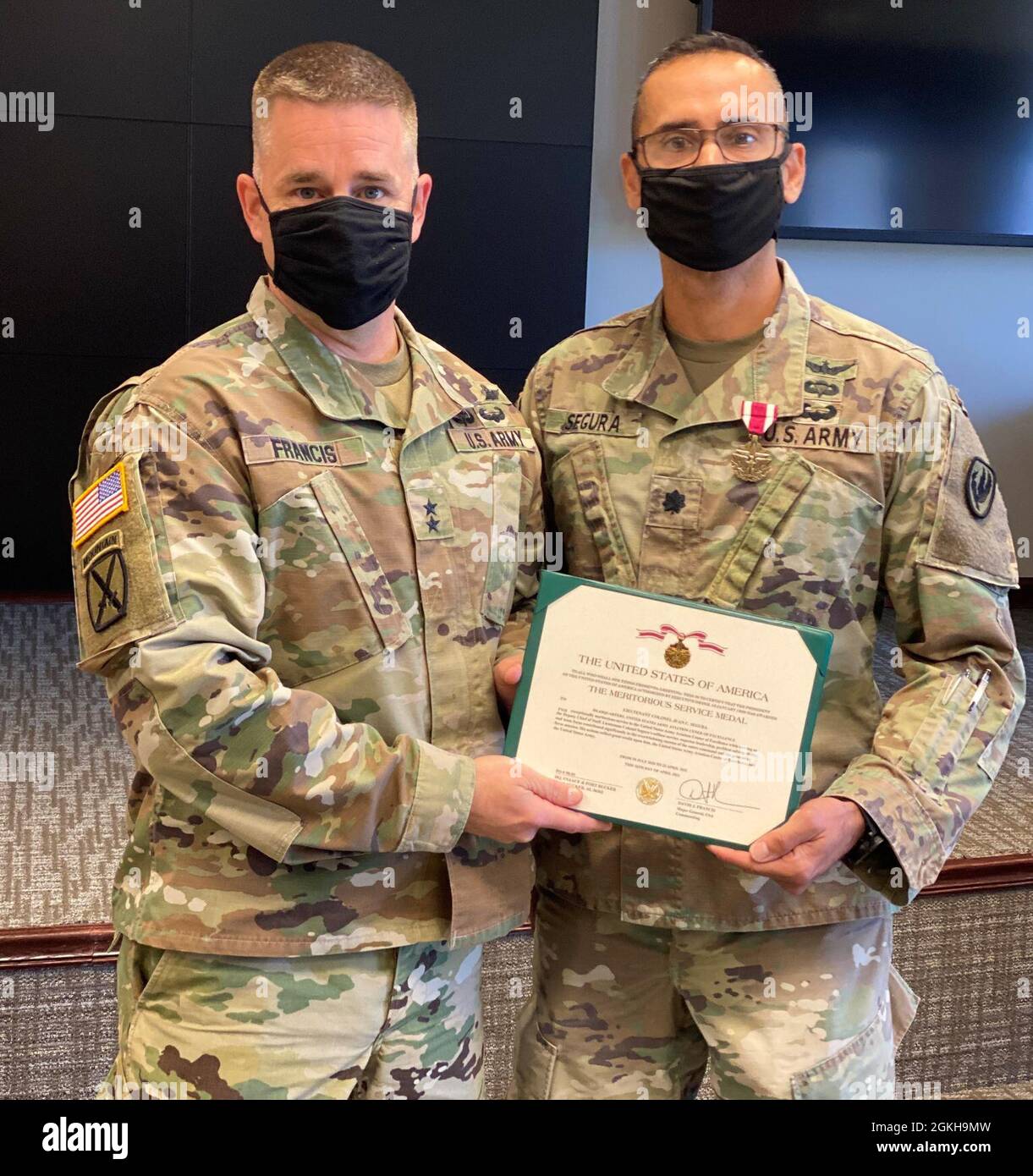 Lt. Col. Juan C. Segura receives the Meritorious Service Medal from Maj ...