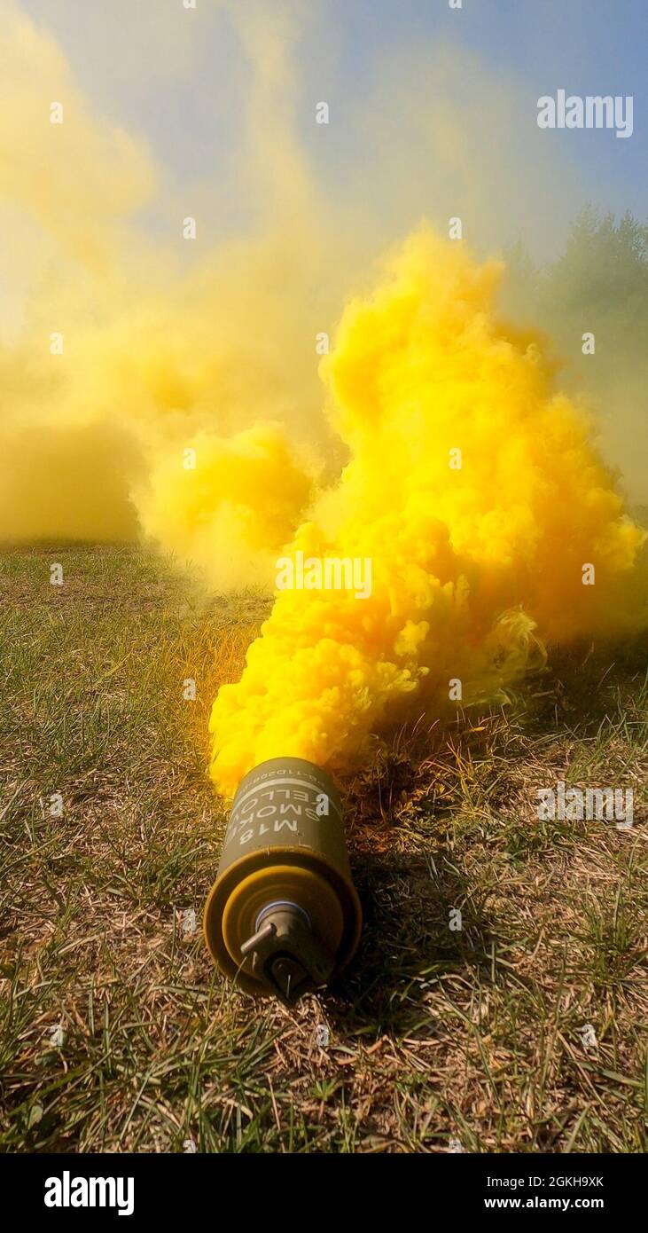An M18 smoke grenade releases yellow smoke during the Chemical ...