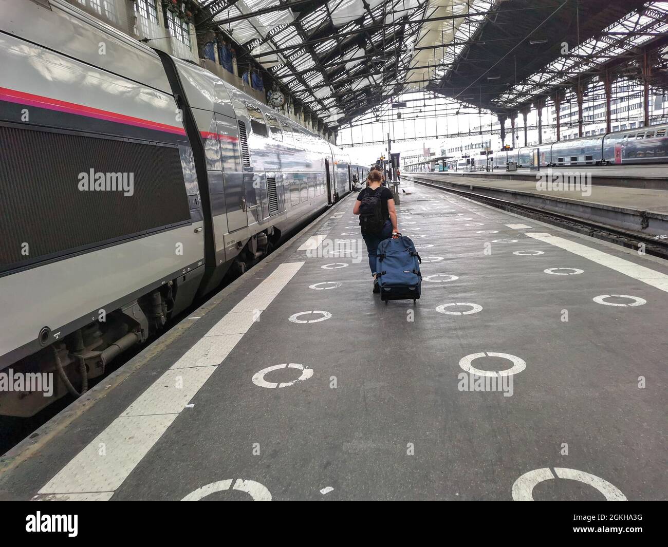 France, Paris, 2021-07-01. A woman pulls a suitcase on the platform of ...