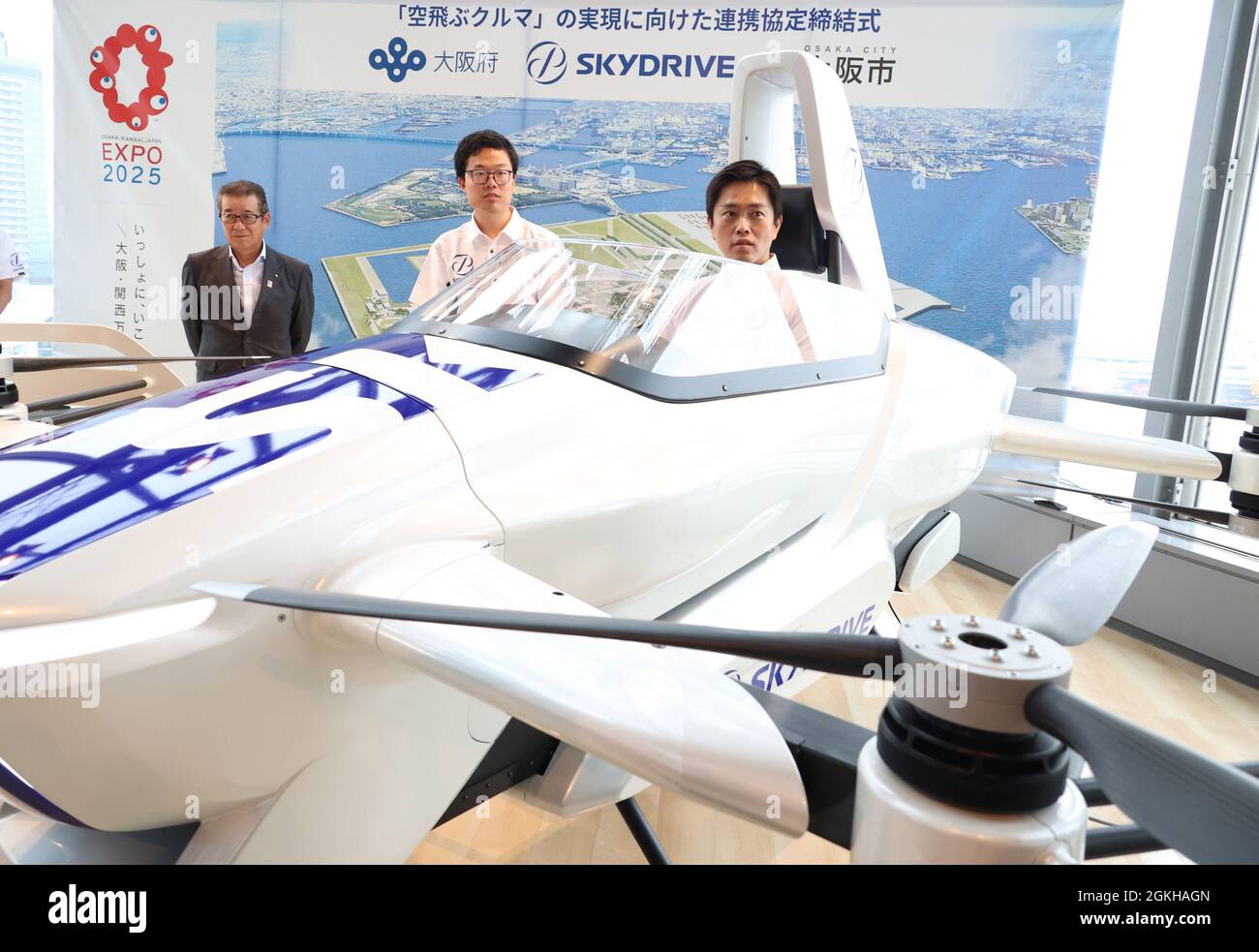 Osaka, Japan. 14th Sep, 2021. Osaka Governor Hirofumi Yoshimura (R) rides a flying vehicle SD-03 ...