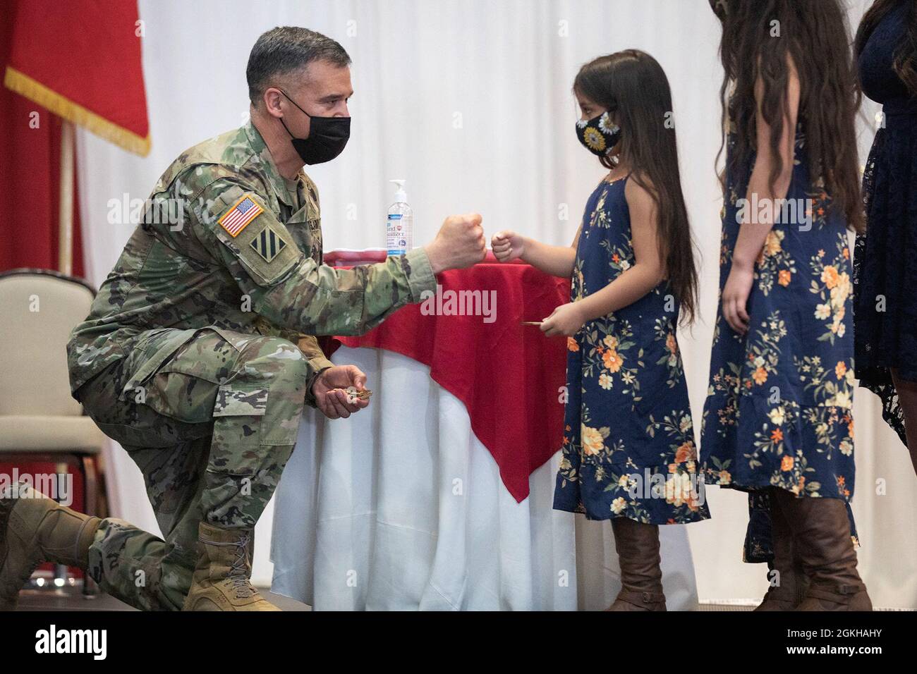 Jaelene Falkenberg, 6, receives a challenge coin from Maj. Gen. Sean ...
