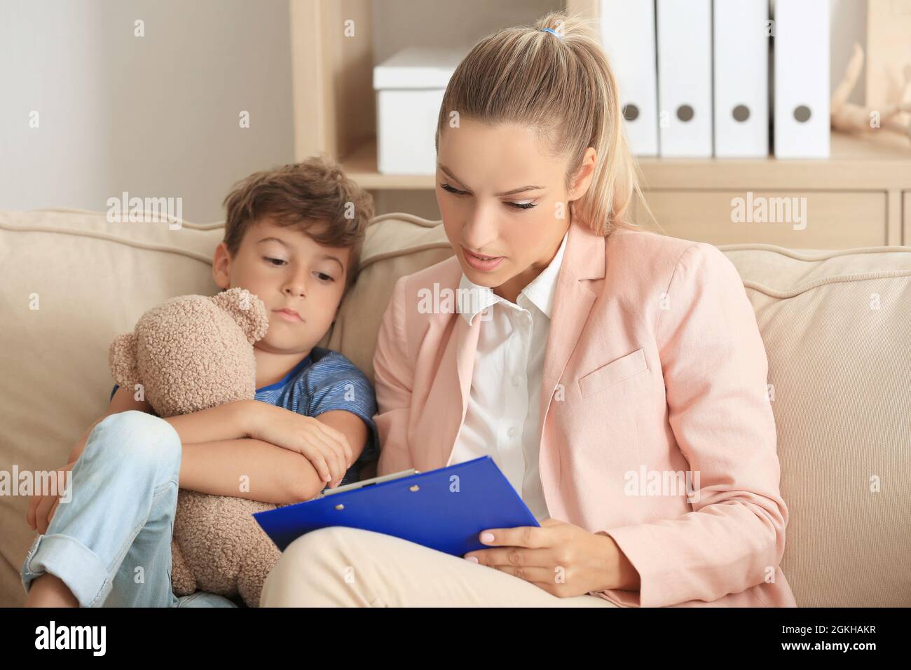 Young psychologist working with little boy in office Stock Photo - Alamy