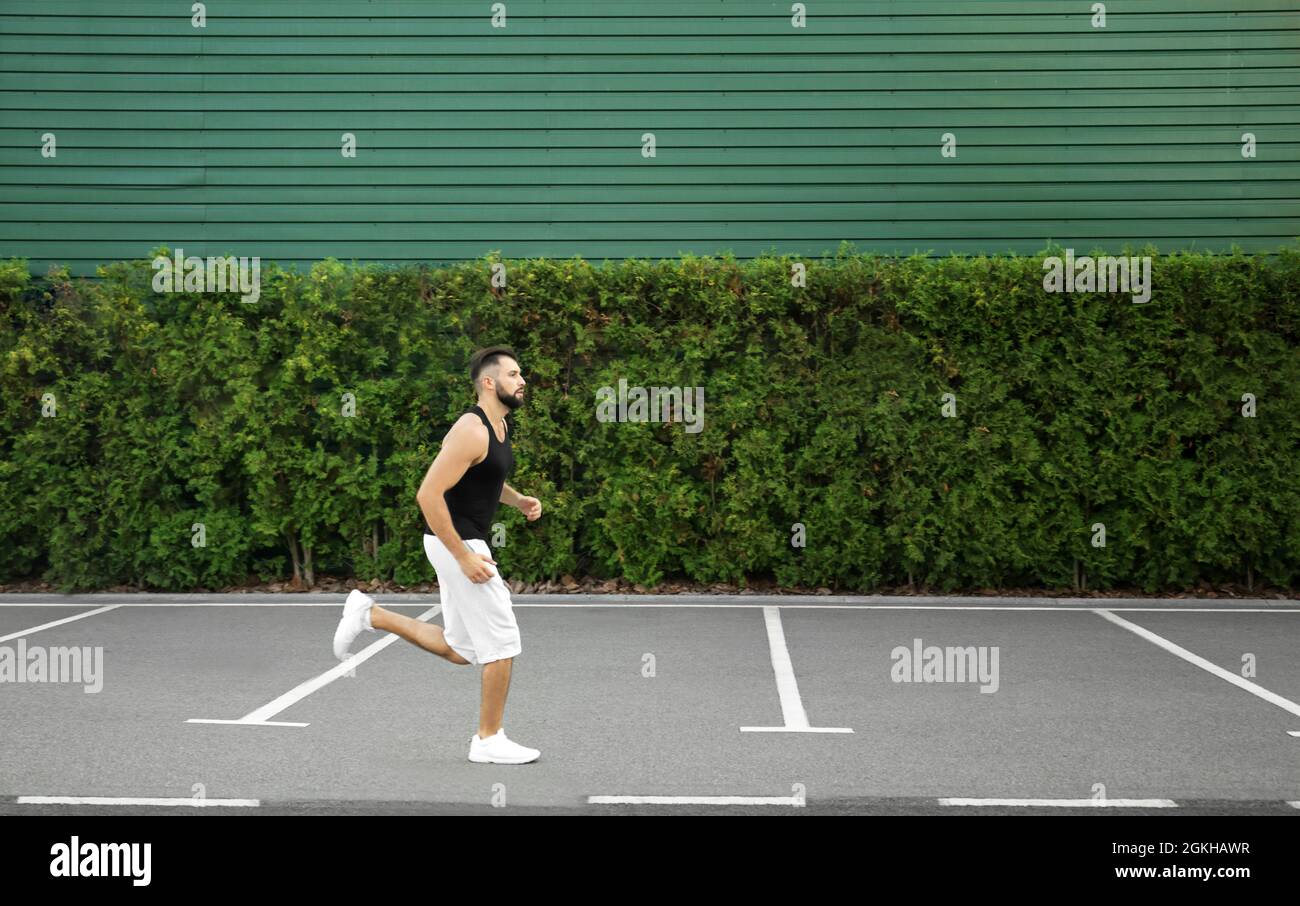 Handsome man running outdoors Stock Photo - Alamy