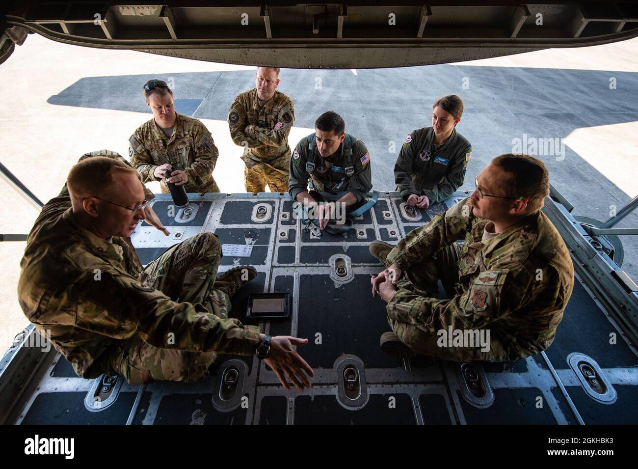 Members of the 153rd Airlift Wing, go over a pre-flight brief on the ...