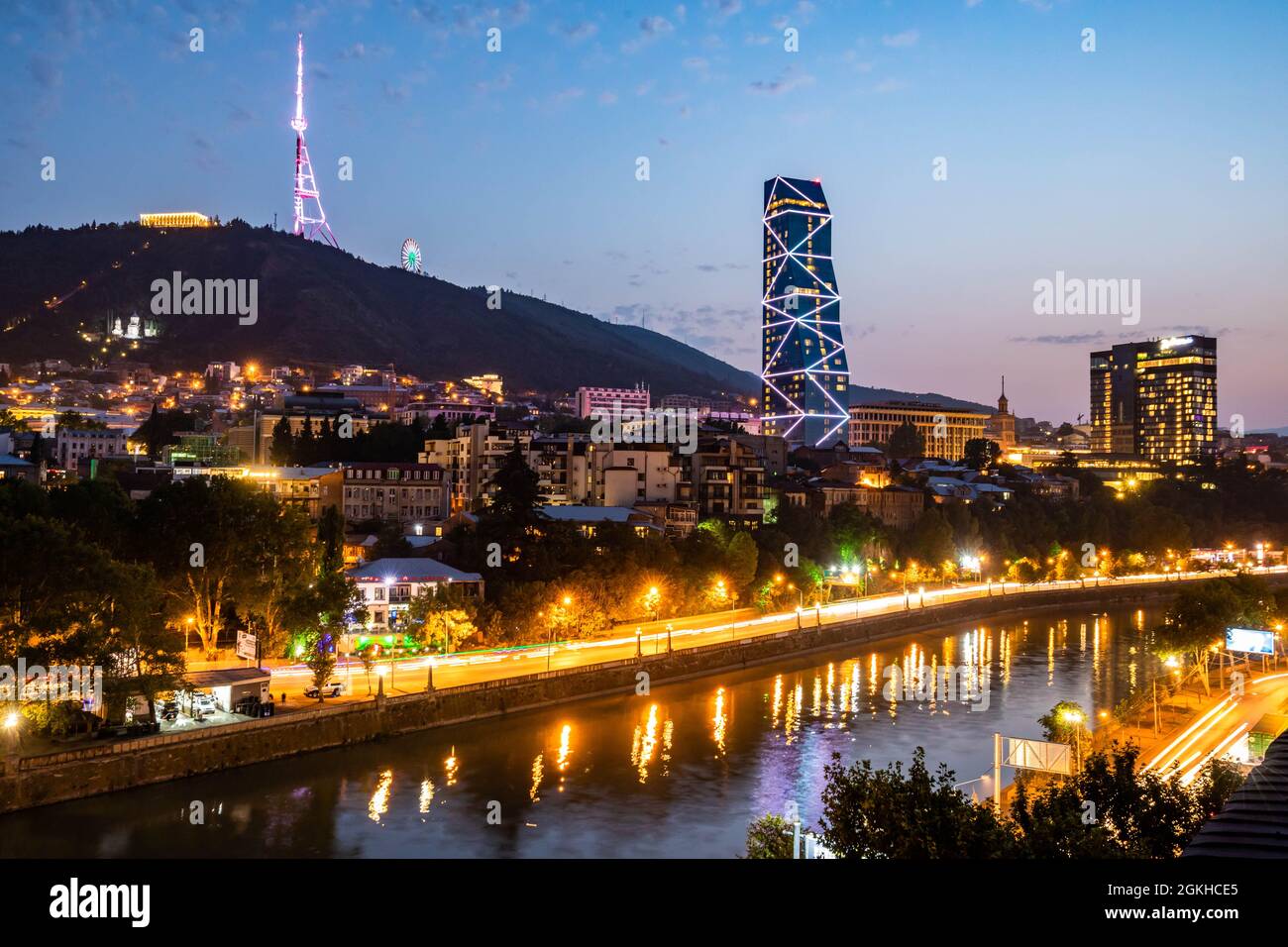 Colorful view of illuminated Mtkvari river in Tbilisi Georgia at night ...