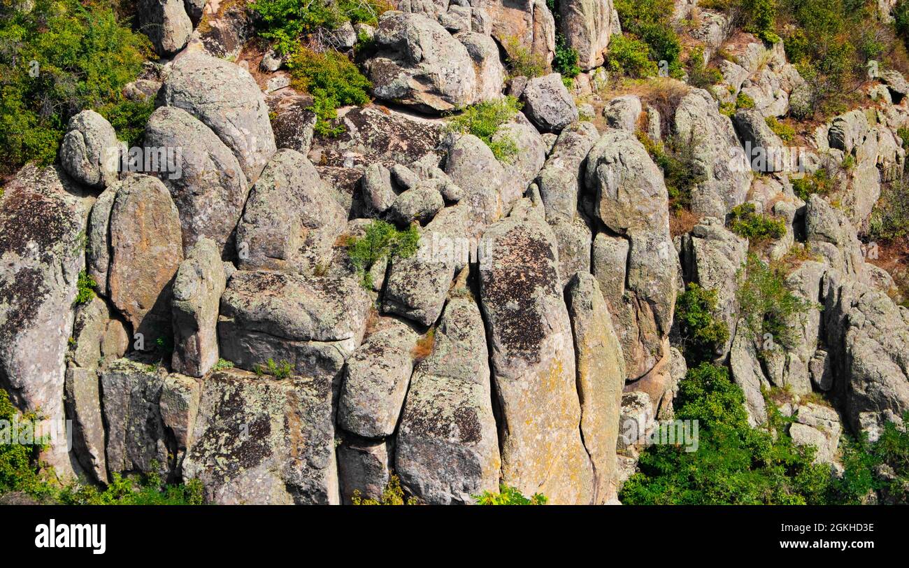 Texture backdrop photo of stone hills wih green grass and trees Stock ...