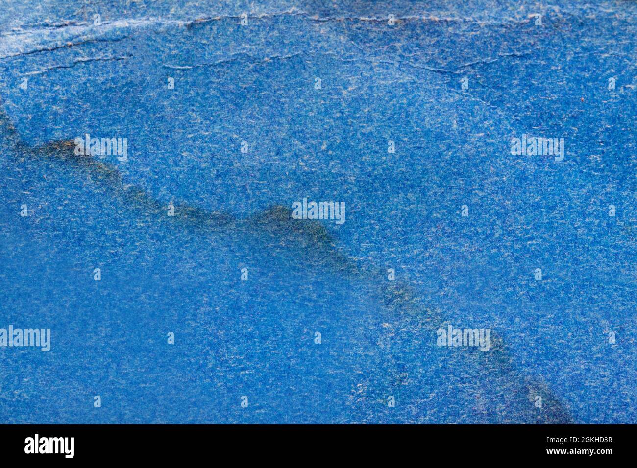 Texture backdrop photo of blue colored old and stained paper sheet ...