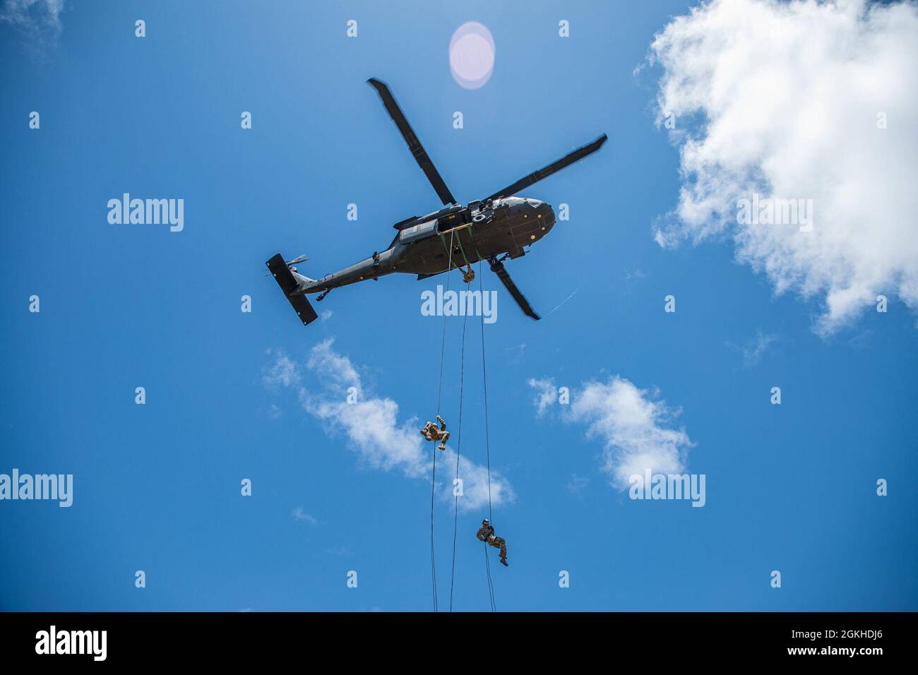 25th Infantry Division Soldiers rappel from a UH-60 Black Hawk during a ...