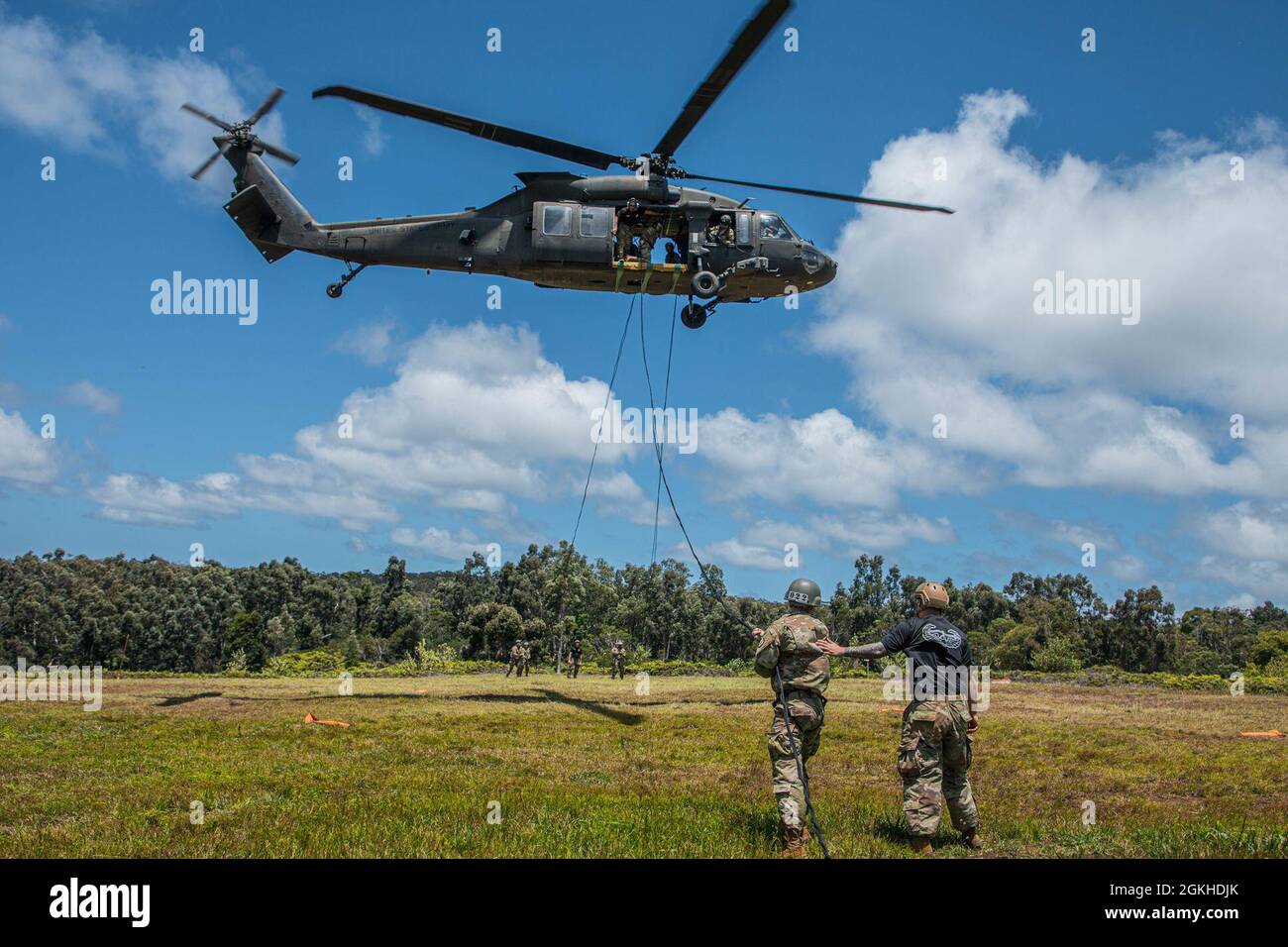 25th Infantry Division Soldiers rappel from a UH-60 Black Hawk during a ...