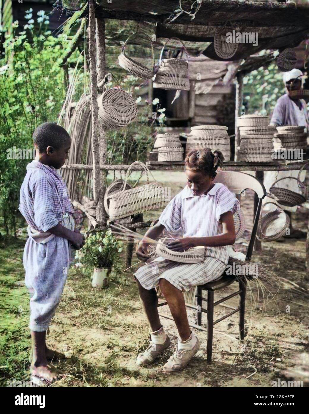 1930s AFRICAN AMERICAN GULLAH BOY STANDING WATCHING GIRL WEAVING BASKET ...