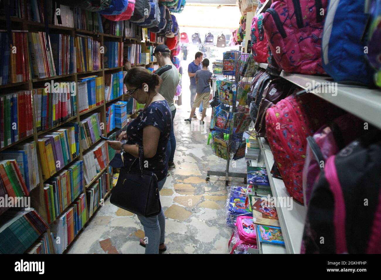 Tripoli, Lebanon. 14th Sep, 2021. A woman looks for school books at a ...