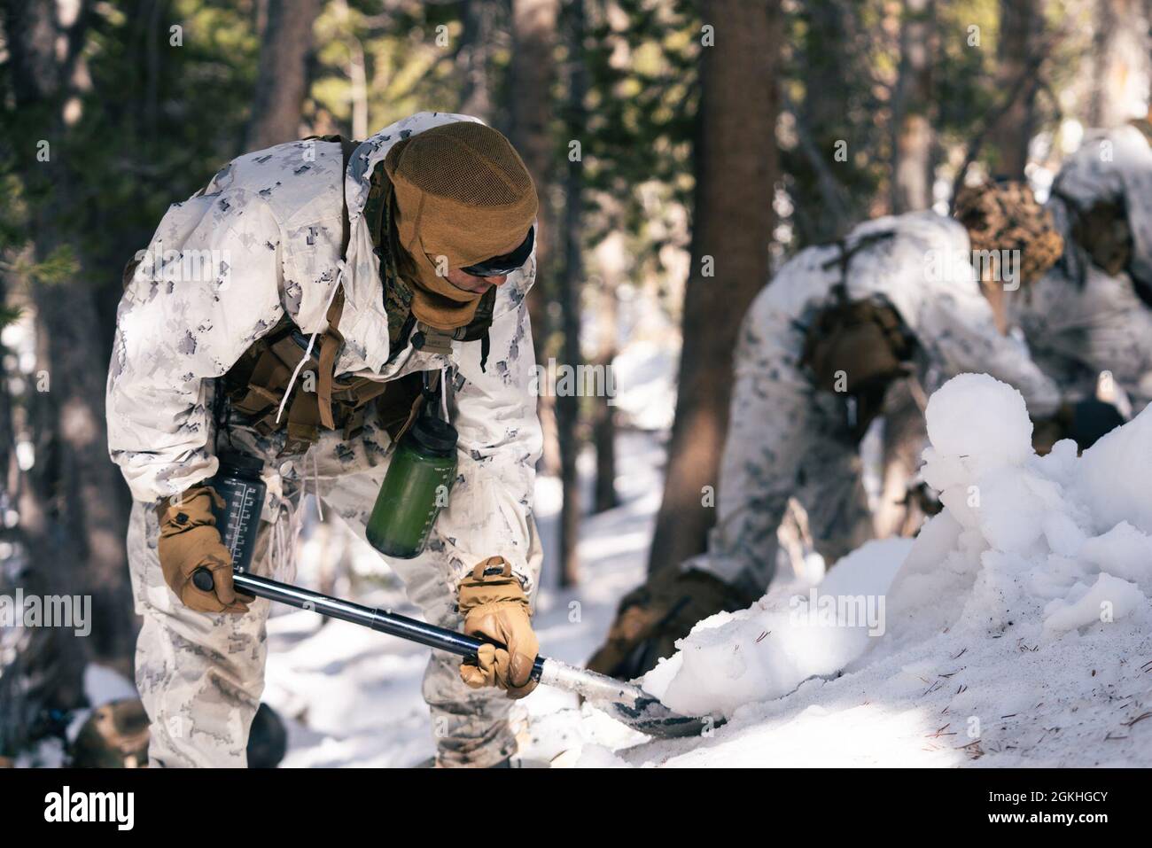 A U.S. Marine with 2nd Battalion, 5th Marine Regiment, shovels snow to ...