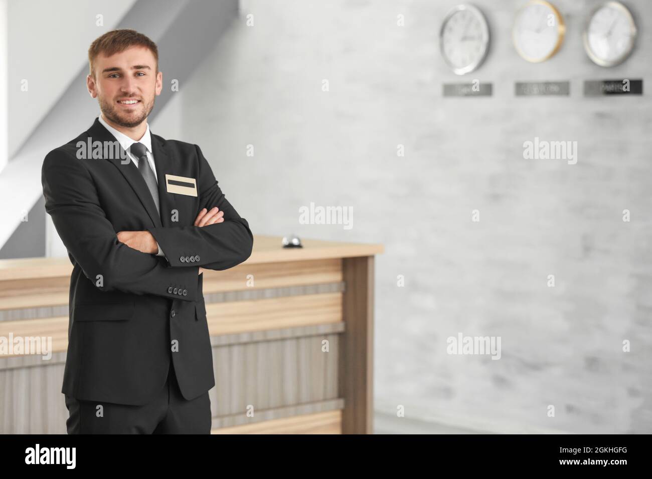 Male hotel receptionist at workplace Stock Photo - Alamy