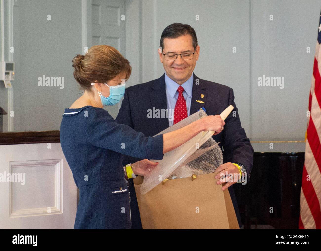 Donald L. Hoffer, executive director, Submarine Forces, gives a gift to ...