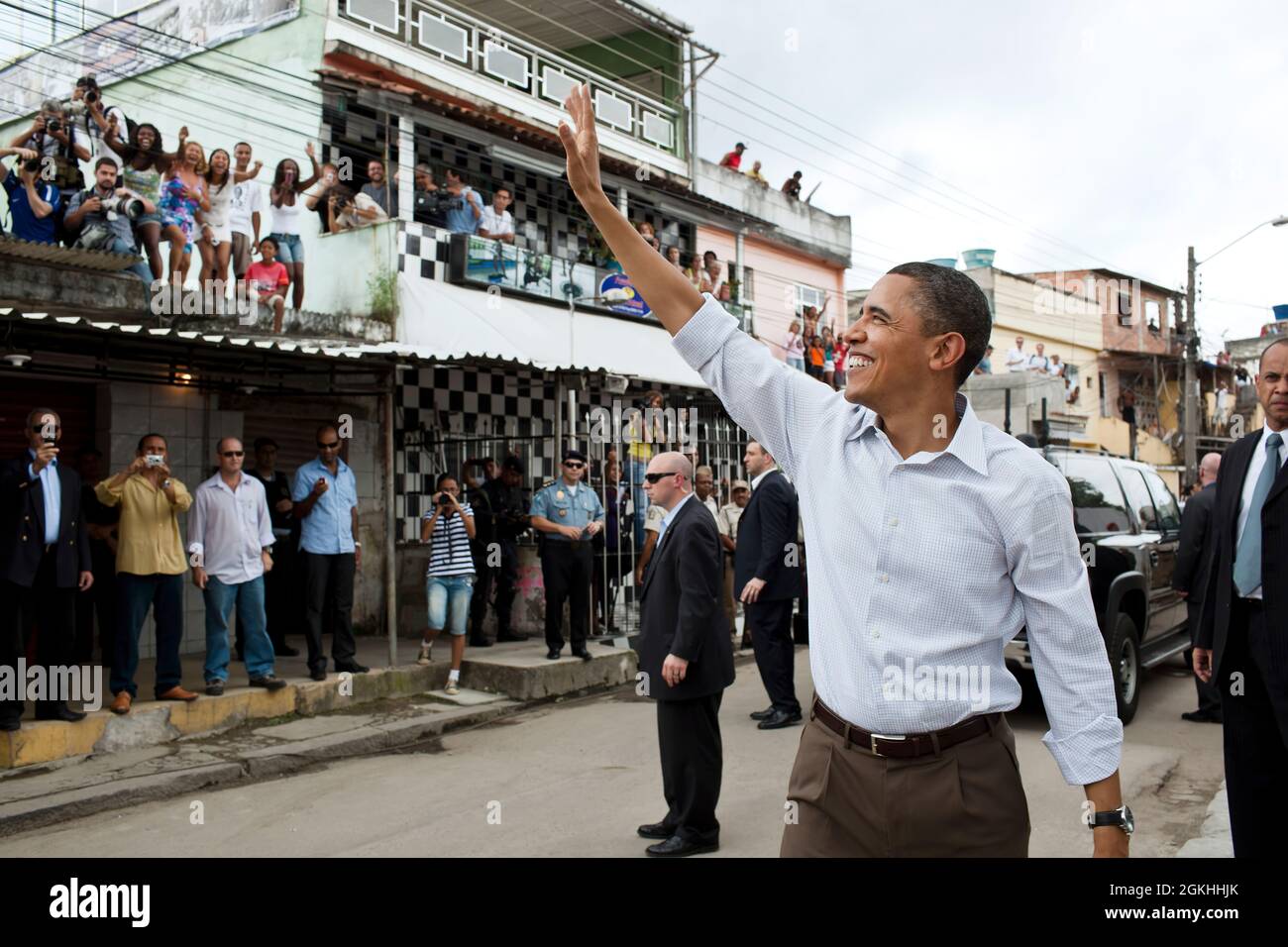 President Barack Obama waves to people gathered on the street outside ...