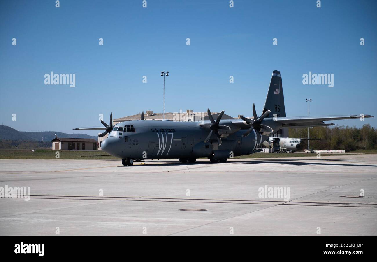 A C-130J Super Hercules aircraft taxis down the runway to meet a UH-60 ...