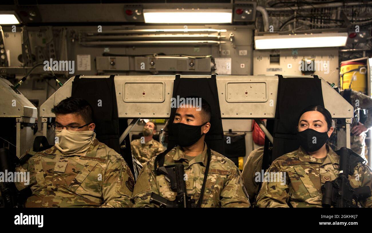 Members of the 349th Security Forces Squadron wait for take-off on a C ...