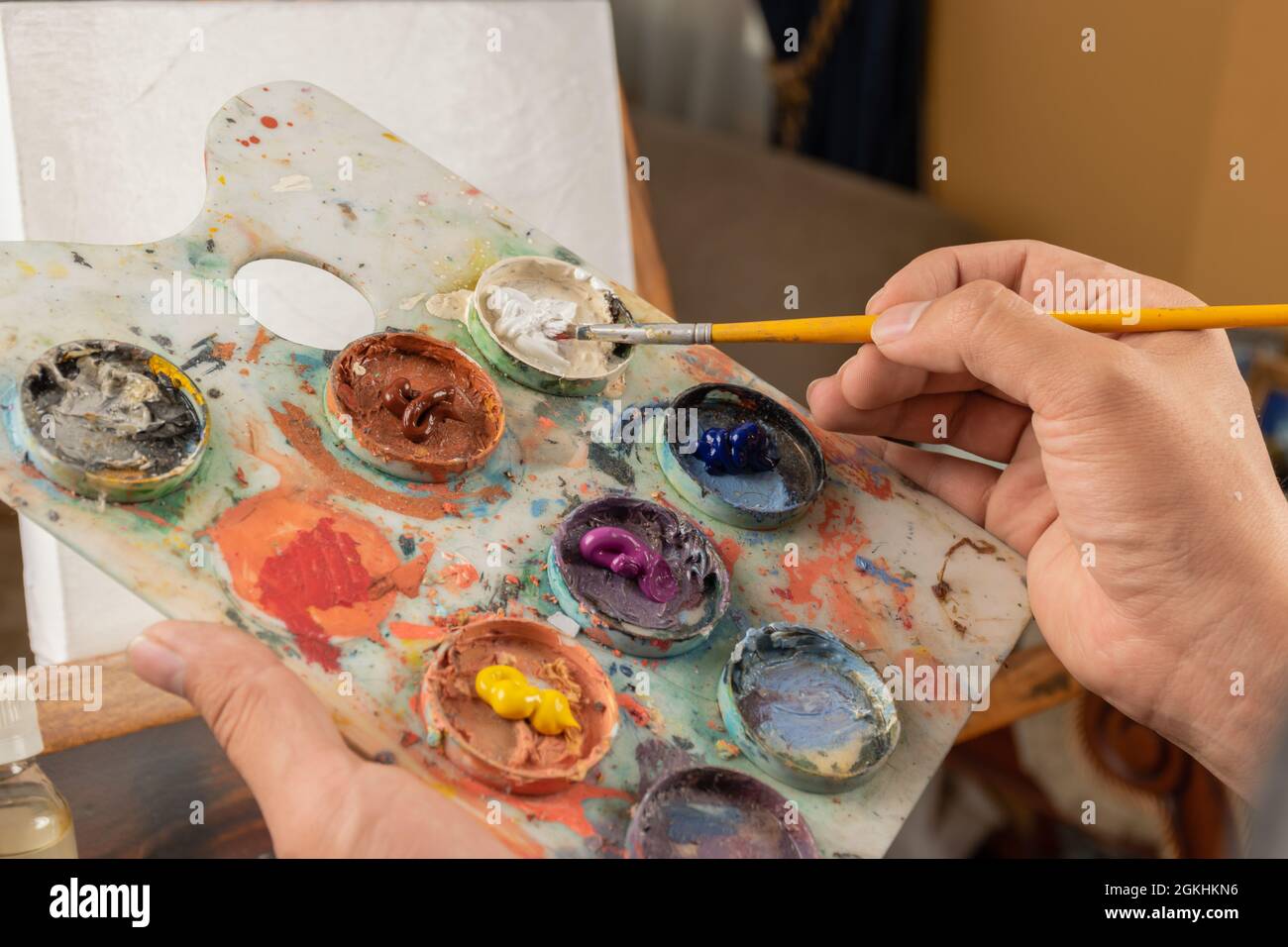 texture details of a paint stained young hand holding a paintbrush ...