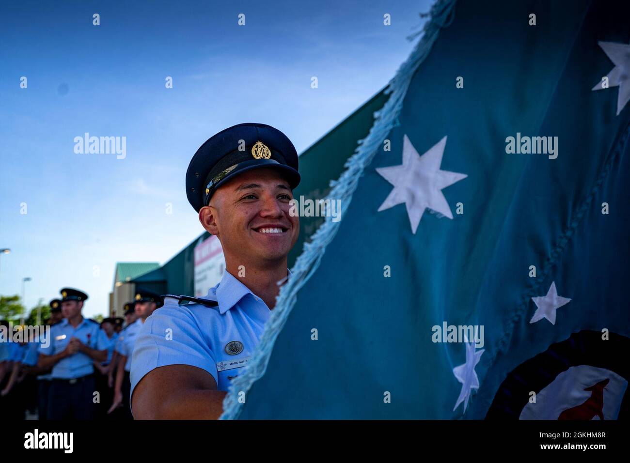 Royal Australian Air Force Cpl. Mark McMaster carries the RAAF ensign ...