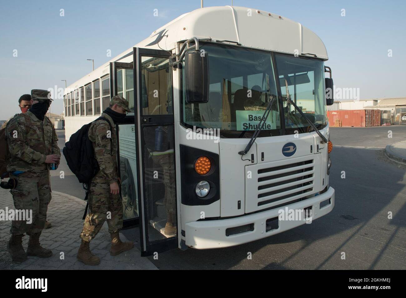 Deployed Airmen load onto a shuttle bus on Al Dhafra Air Base, United ...