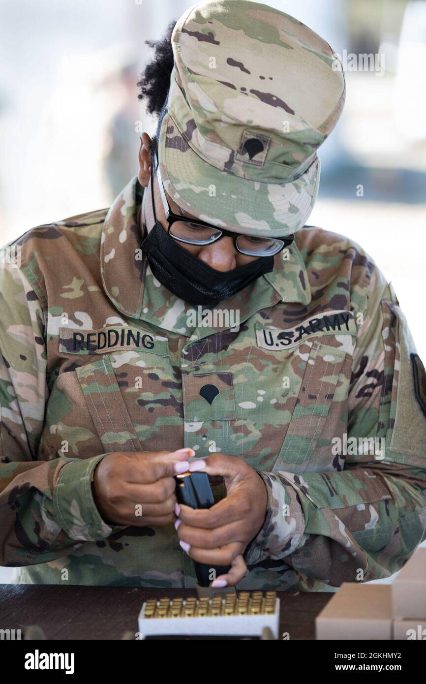 U.S. Army Spc. Veronica Redding with the 1st 321st, loads magazines ...