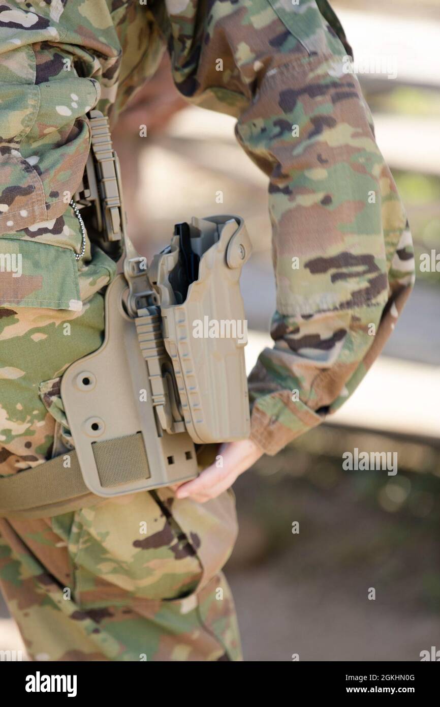 U.S Army Soldiers put on holsters in preparation for the M17 ...