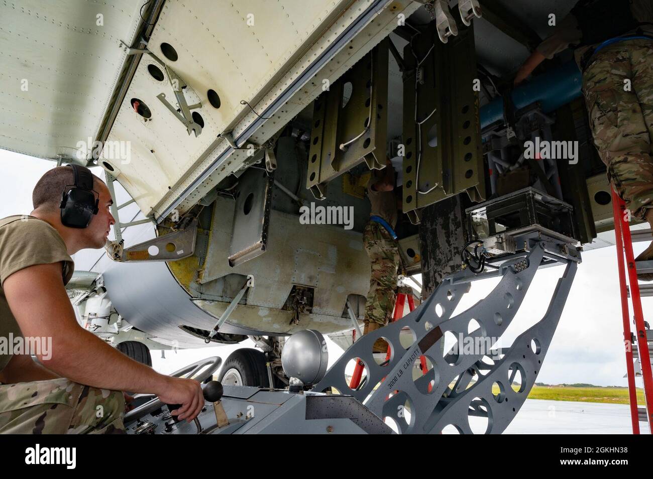 U.S. Air Force Airmen attach a BDU-50 chronicle bomb to a B-52H ...