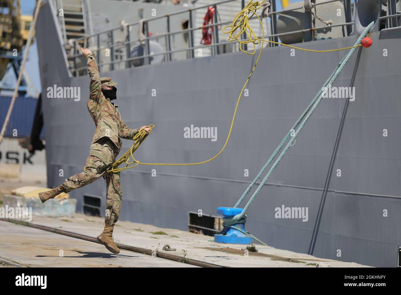 U.S. Army Spc. Richard Robert-Effinger throws a secure line aboard the ...