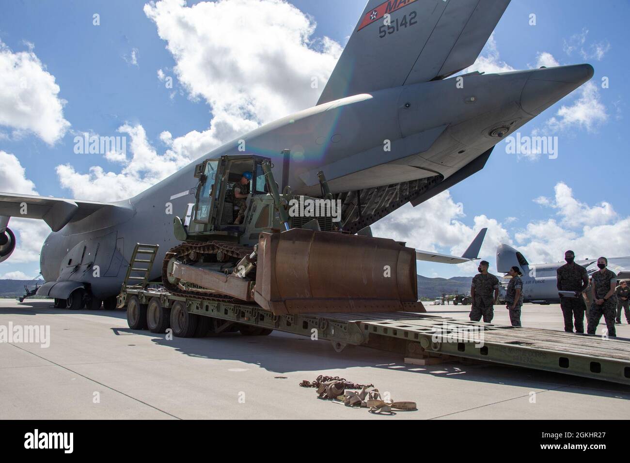 U.S. Marines and airmen prepare to load a 850JR crawler dozer into an ...