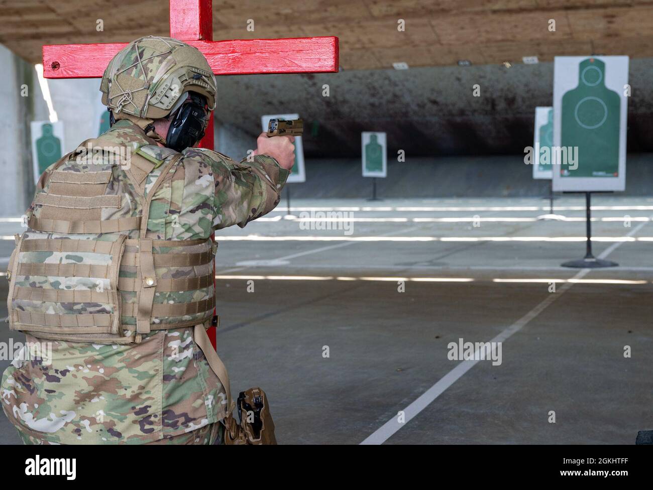 Col. Matthew Jones, 436th Airlift Wing commander, aims an M18 pistol at ...