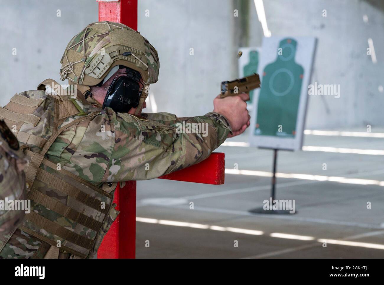 Col. Matthew Jones, 436th Airlift Wing commander, fires an M18 pistol ...